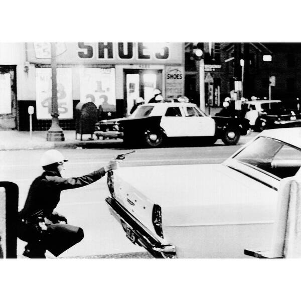 1965 Watts Riots. A Policeman Aims His Revolver At Building Where A ...