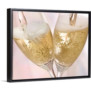 "Two champagne flutes being filled with sparkling champagne in ...