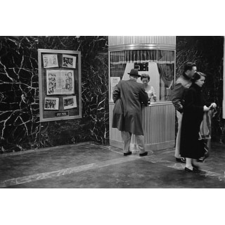 Man Purchasing A Movie Ticket From A Woman In A Ticket Booth As A ...
