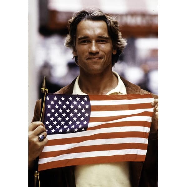 Arnold Schwarzenegger holding an American flag Photo Print - Bed Bath ...