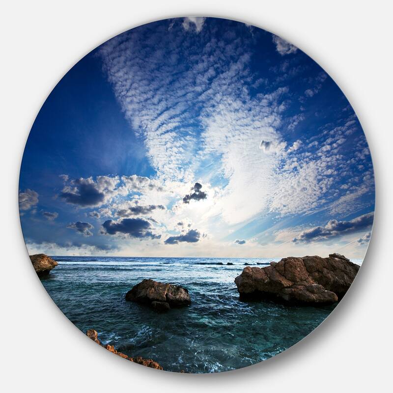 Designart 'Rocky Beach with White Clouds' Modern Beach Circle Wall Art ...