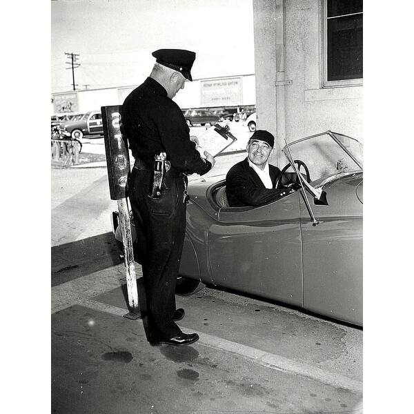 Clark Gable with a security guard at the gate to MGM Studios Photo ...