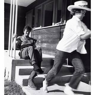 John Wayne sitting on stairs and a woman running away Photo Print - Bed ...