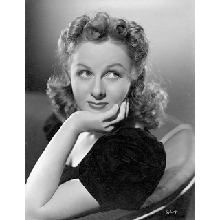 Susan Hayward sitting and Face Leaning on Hand on Chair in Black Dress ...