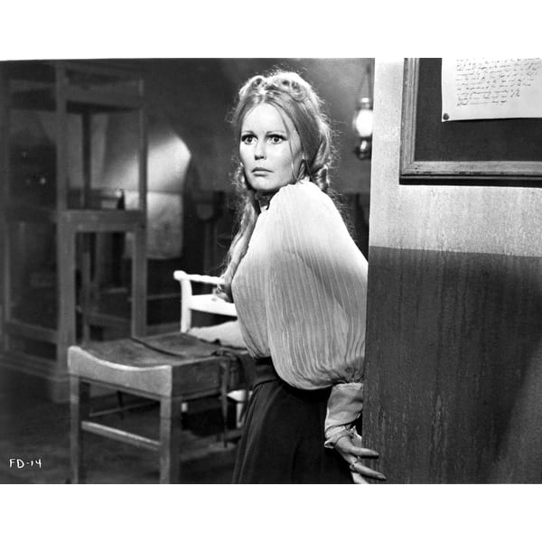 Veronica Carlson clutching corner of the wall wearing black skirt and ...