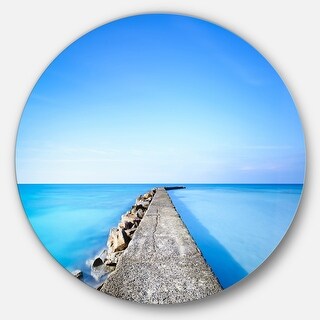 Designart 'Concrete and Rocks Pier' Seascape Photo Circle Wall Art ...