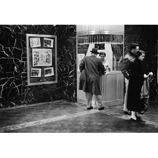 Man Purchasing A Movie Ticket For The Film The Coming Attraction Is The ...