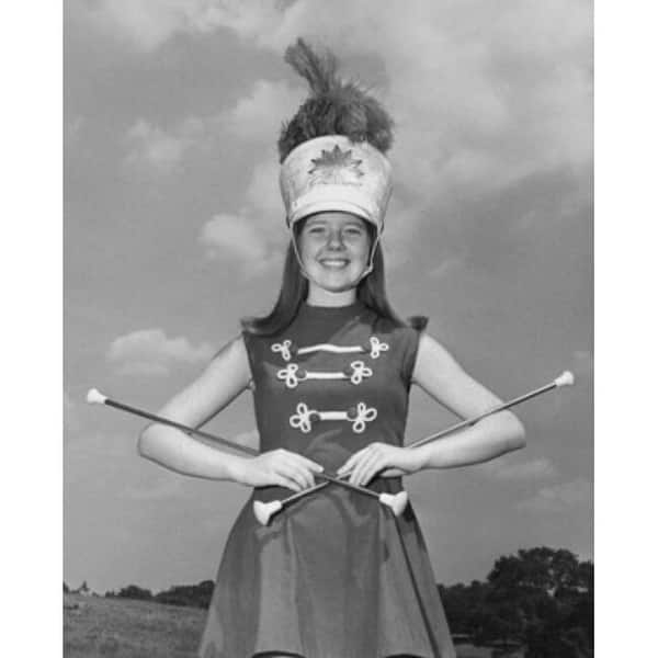 Drum Majorette Performing With Two Twirling Batons And Smiling Poster
