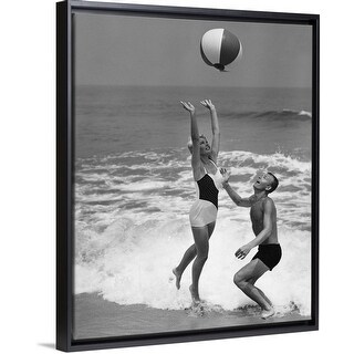 "Young couple playing with beach ball at water's edge" Black Float ...
